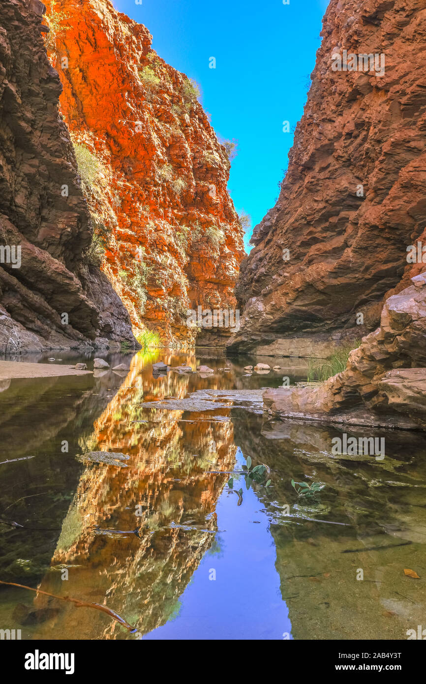 Simpsons Gap and permanent waterhole reflects the cliffs in West ...