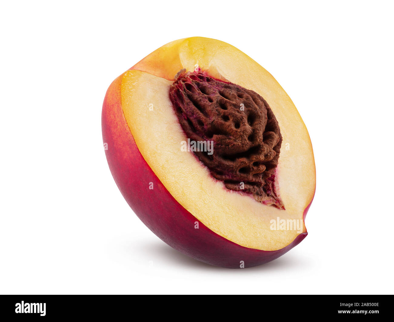 Smooth-skinned nectarine fruit with kernel isolated on white background ...