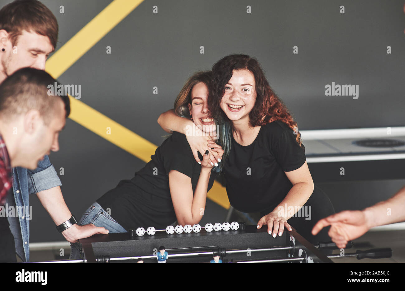 Friends together play board games, table football Stock Photo - Alamy
