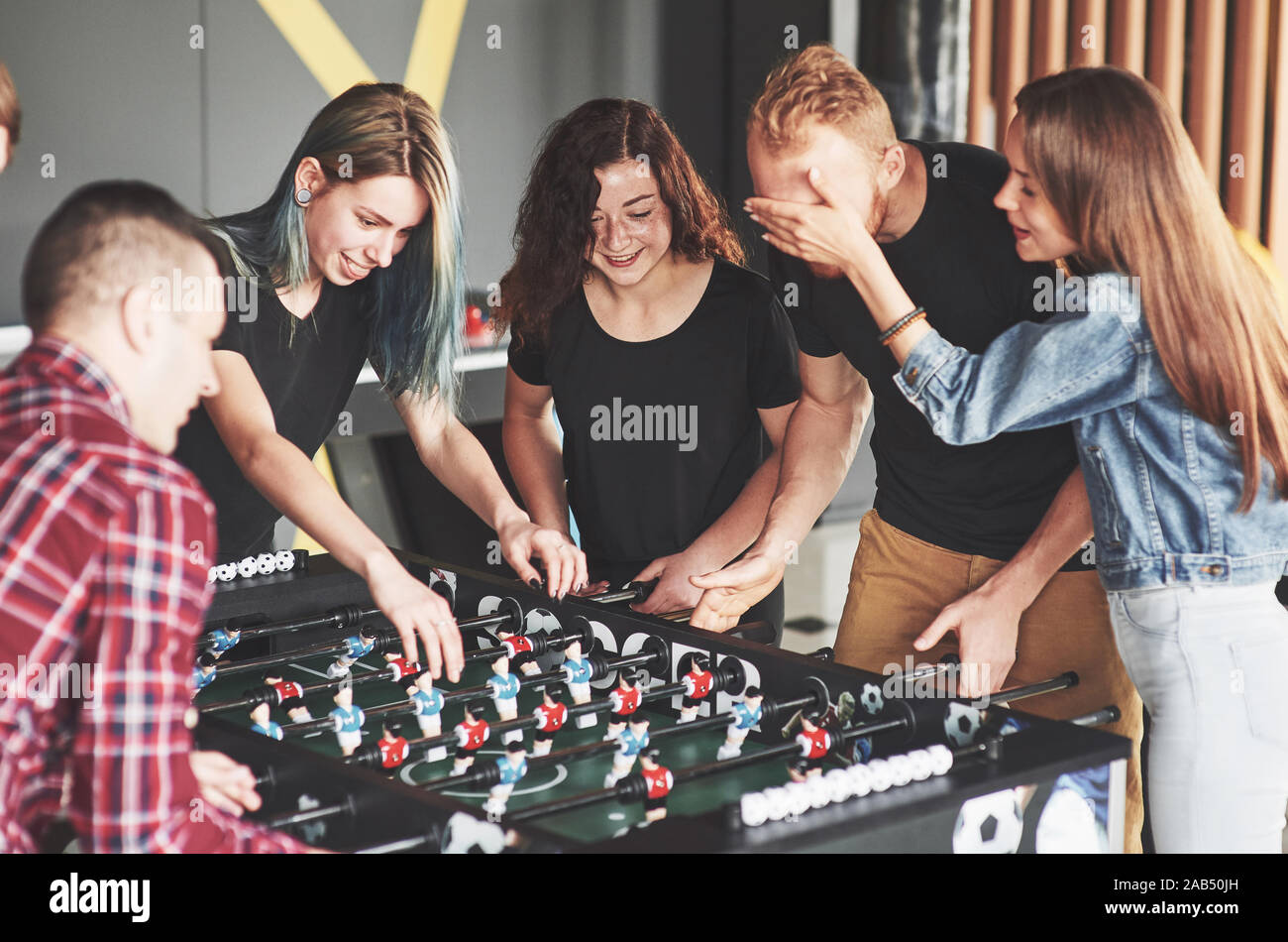 Friends together play board games, table football Stock Photo - Alamy