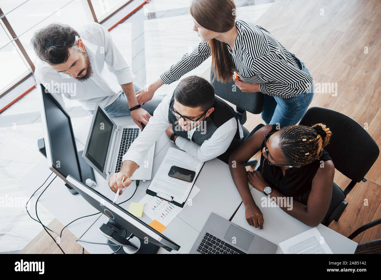 A group of multinational busy people working in the office Stock Photo ...