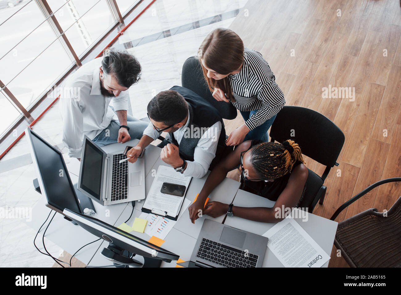 A group of multinational busy people working in the office Stock Photo ...