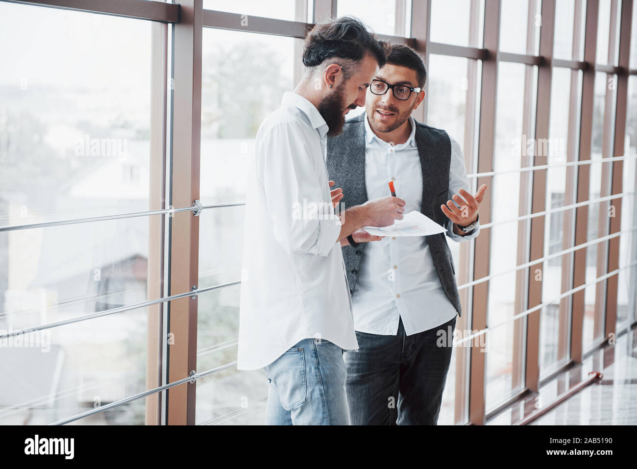 Young business people are discussing new creative ideas together during ...