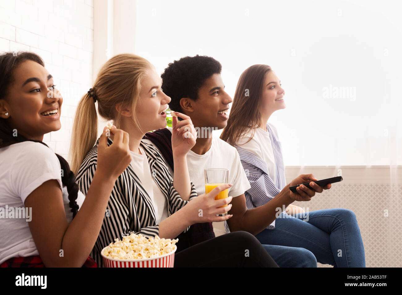 Best friends watching film and eating popcorn Stock Photo - Alamy