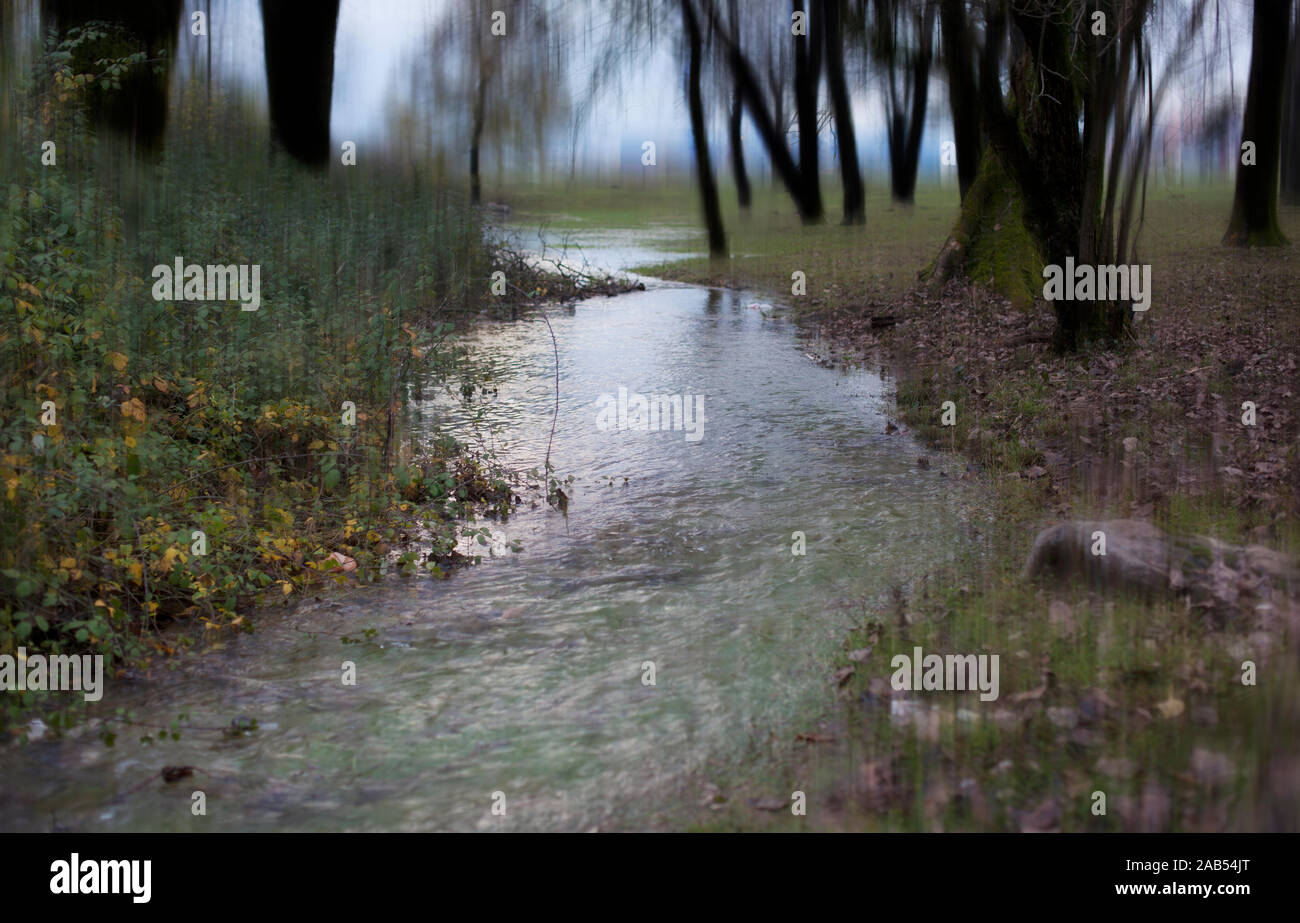 The river runs through the forest. Blurred background Stock Photo - Alamy