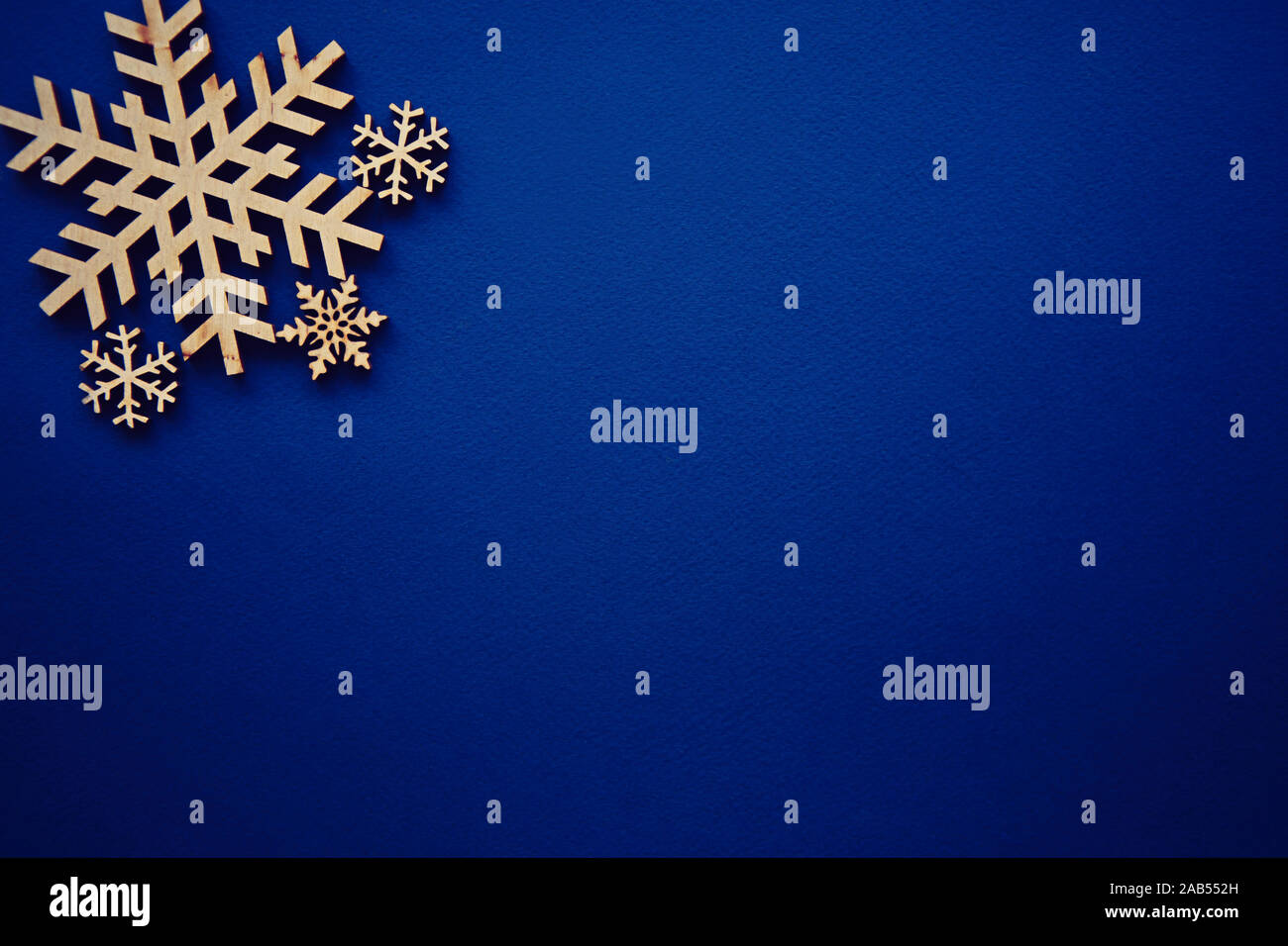 Blue winter holiday background with handmade wooden snowflake.Paper ...