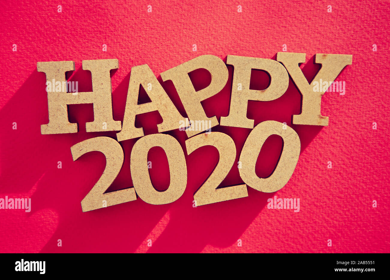 Happy 2020 background.Red paper backdrop,rustic wooden letters in flat ...