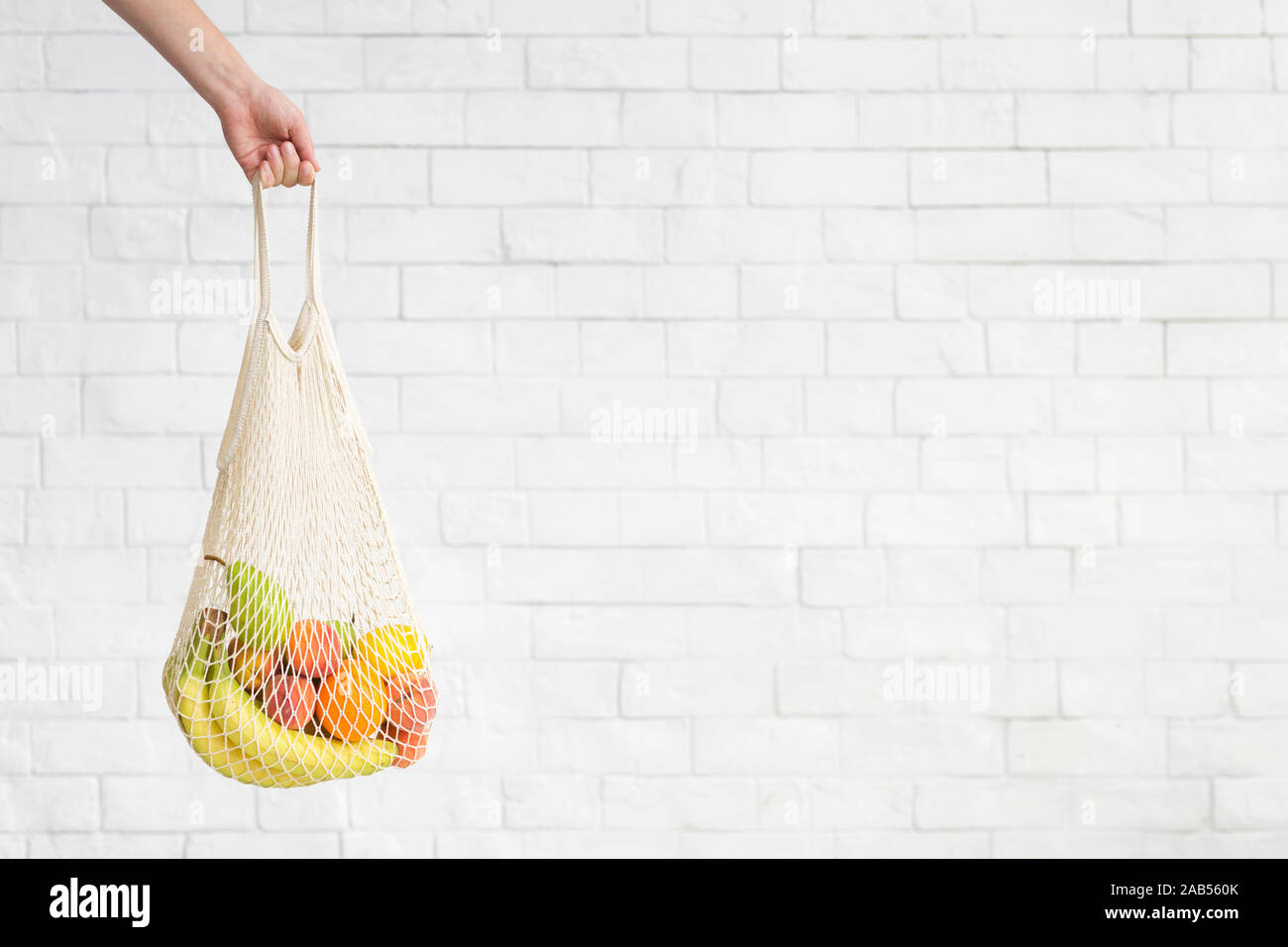 Woman carrying Healthy products composition in reusable net bag Stock ...