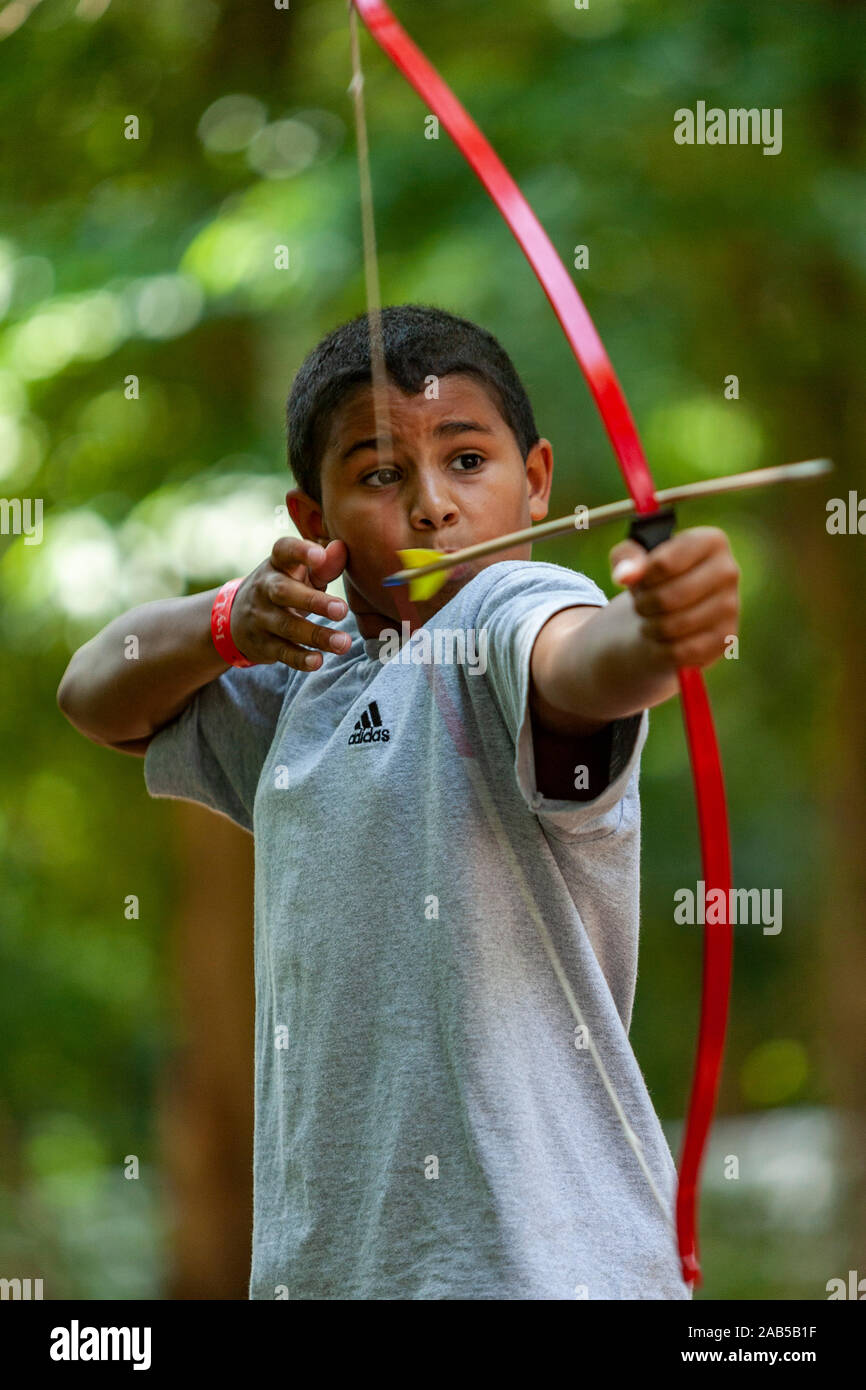 Boys playing archery at day camp Stock Photo - Alamy
