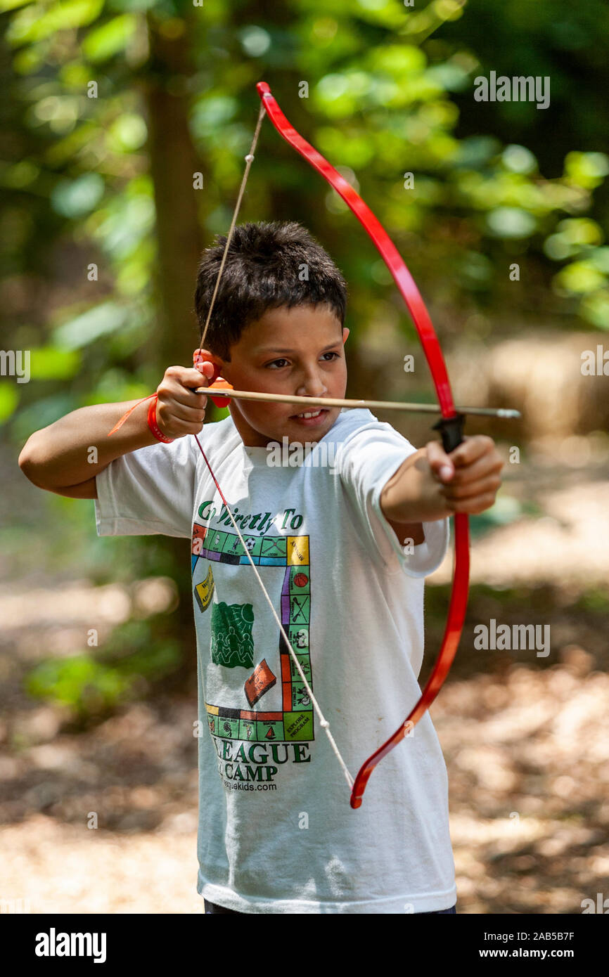 Boys playing archery at day camp Stock Photo - Alamy