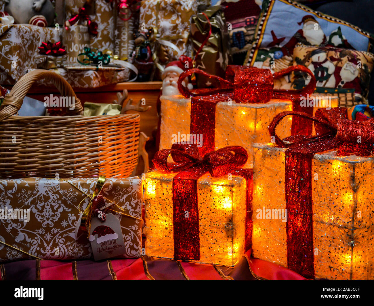 Many packed Christmas presents with decoration and lit cubes that look ...
