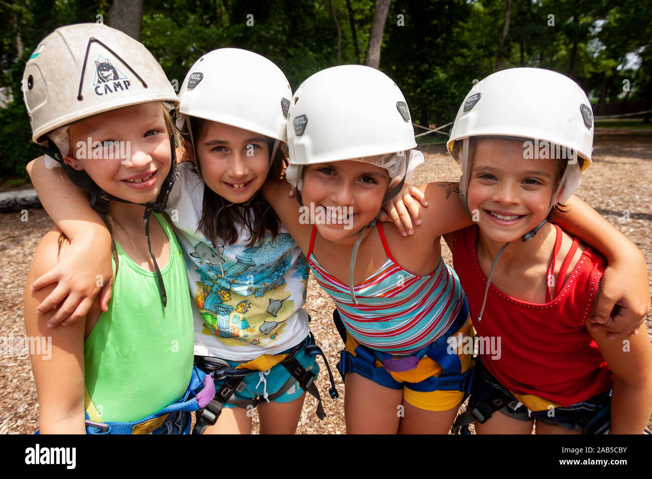 Girl on zip line at day camp Stock Photo - Alamy