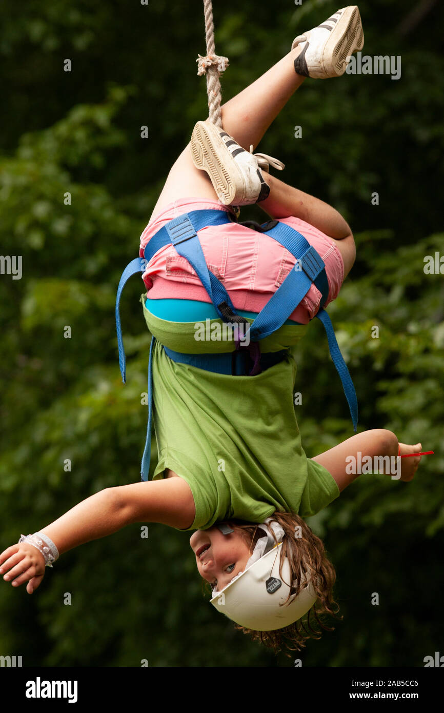 Girl on zip line at day camp Stock Photo - Alamy