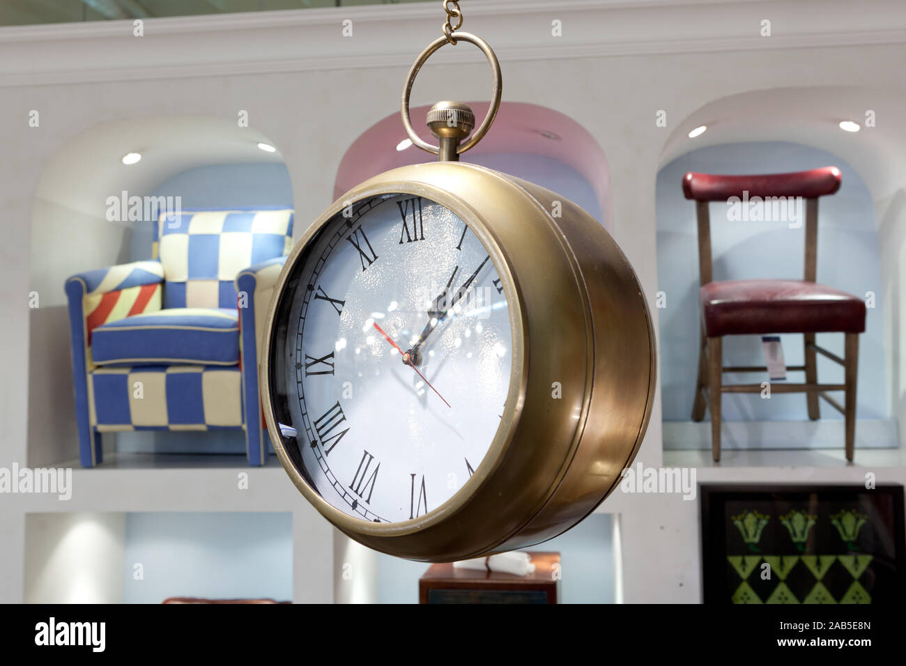 Large clock in a metal case in the interior Stock Photo - Alamy