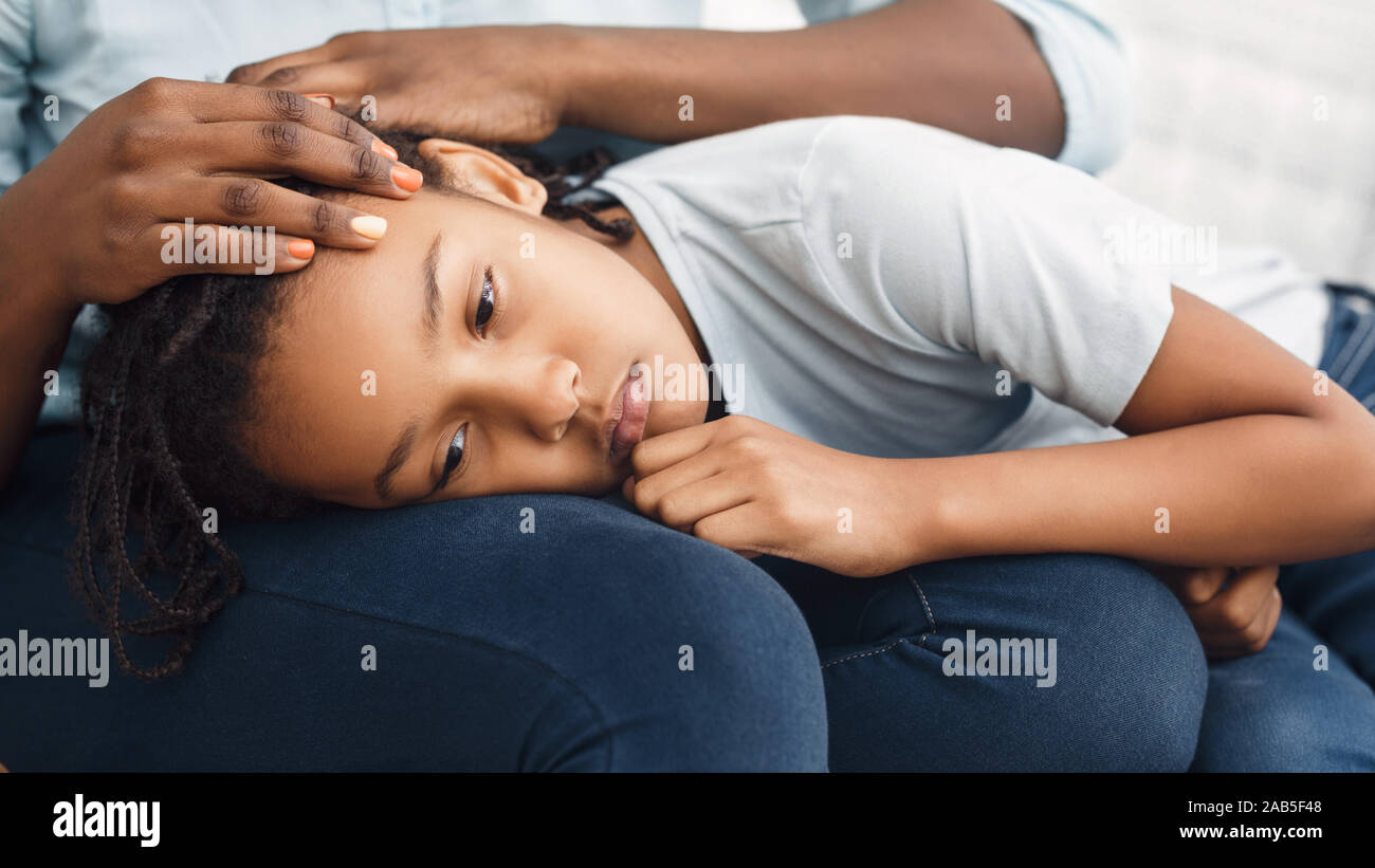 Close-up of black girl's head laying on lap Stock Photo - Alamy