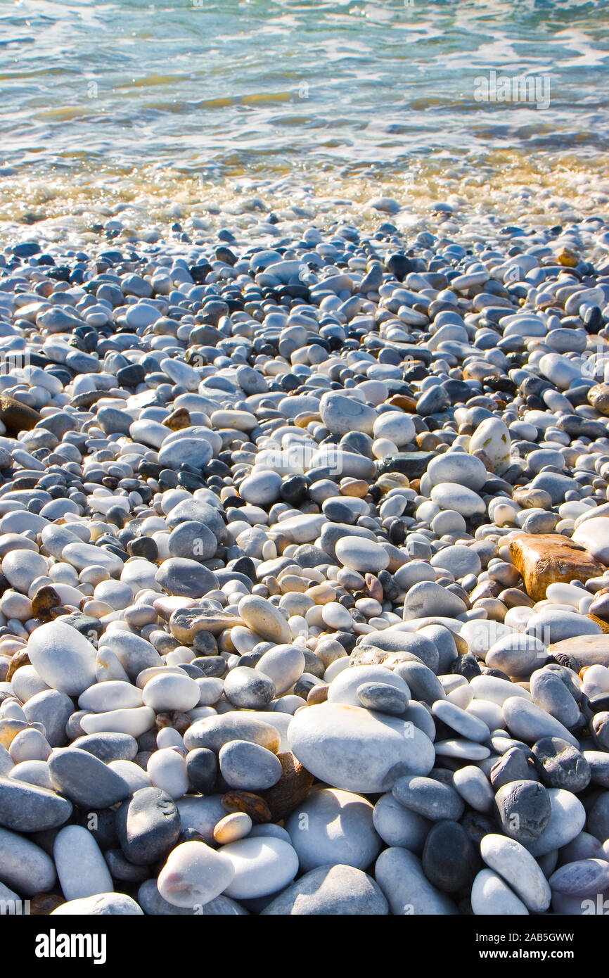 Rounded and smooth pebbles wet by seawater Stock Photo - Alamy
