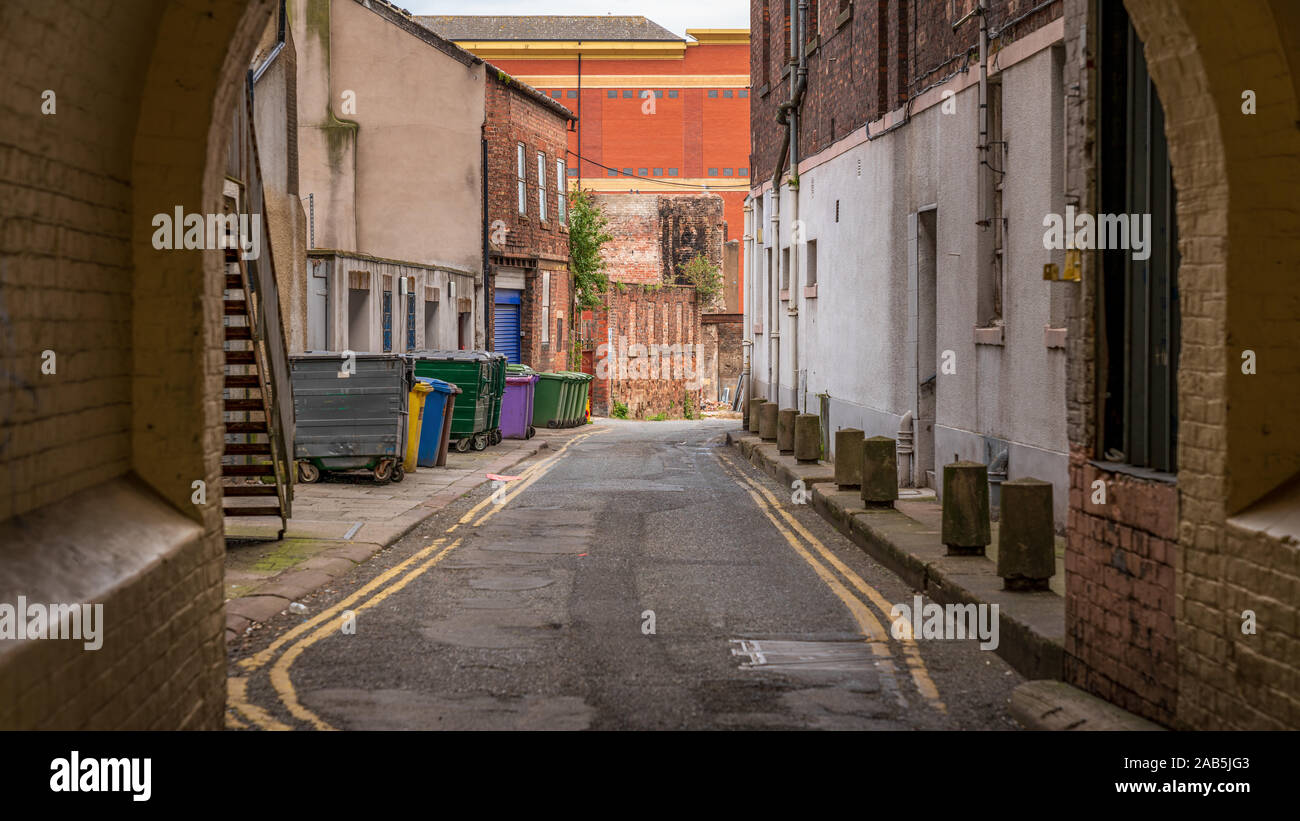 A small road with garbage containers on the side, seen in Carlisle ...
