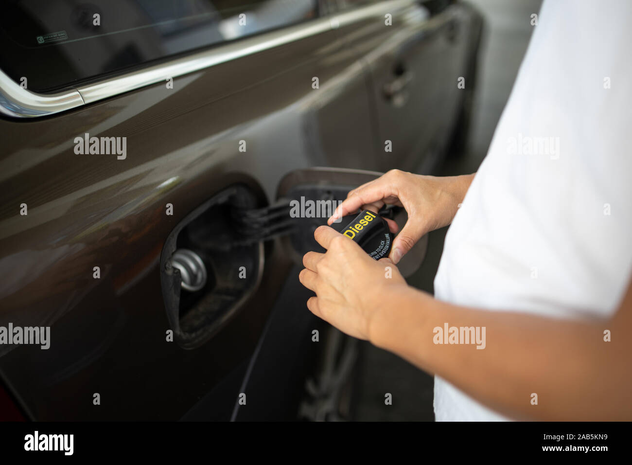 Car pumping gas at gas pump. Closeup of man pumping gasoline fuel in ...