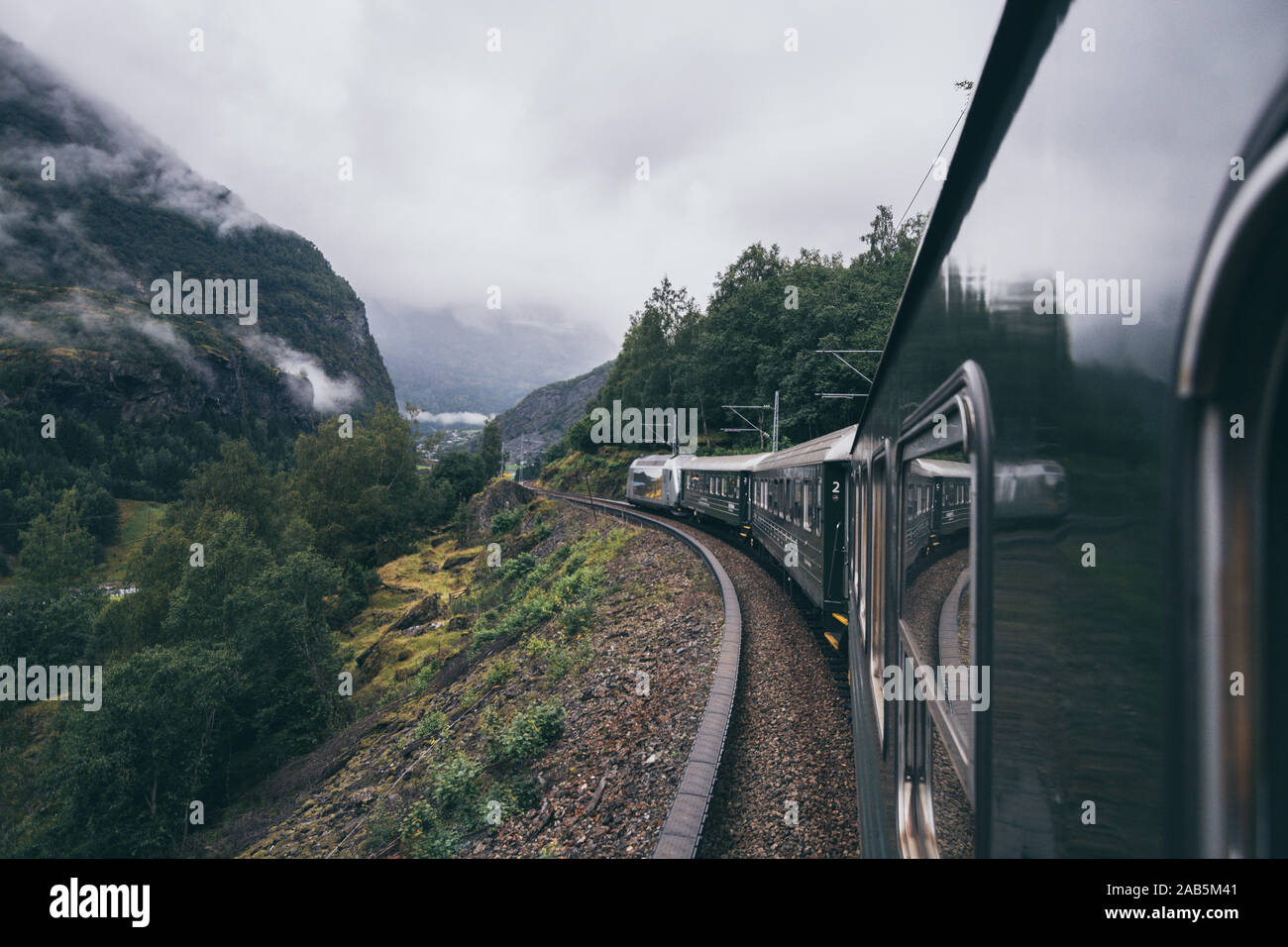 Reflection in train window of Flamsbana mountain railway in Flam ...