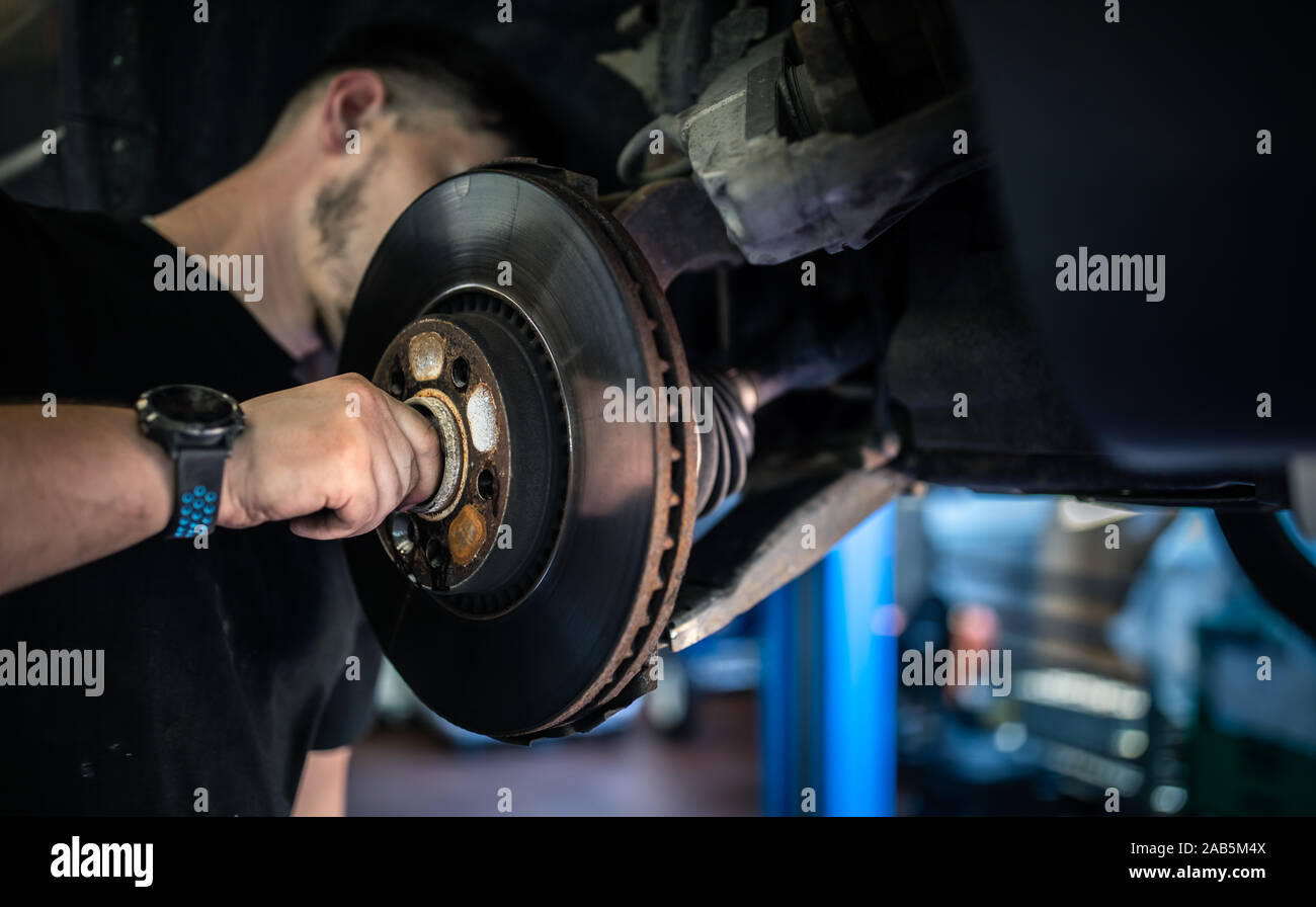 Wheel bearing repair at auto service/garage or workshop by mechanic ...