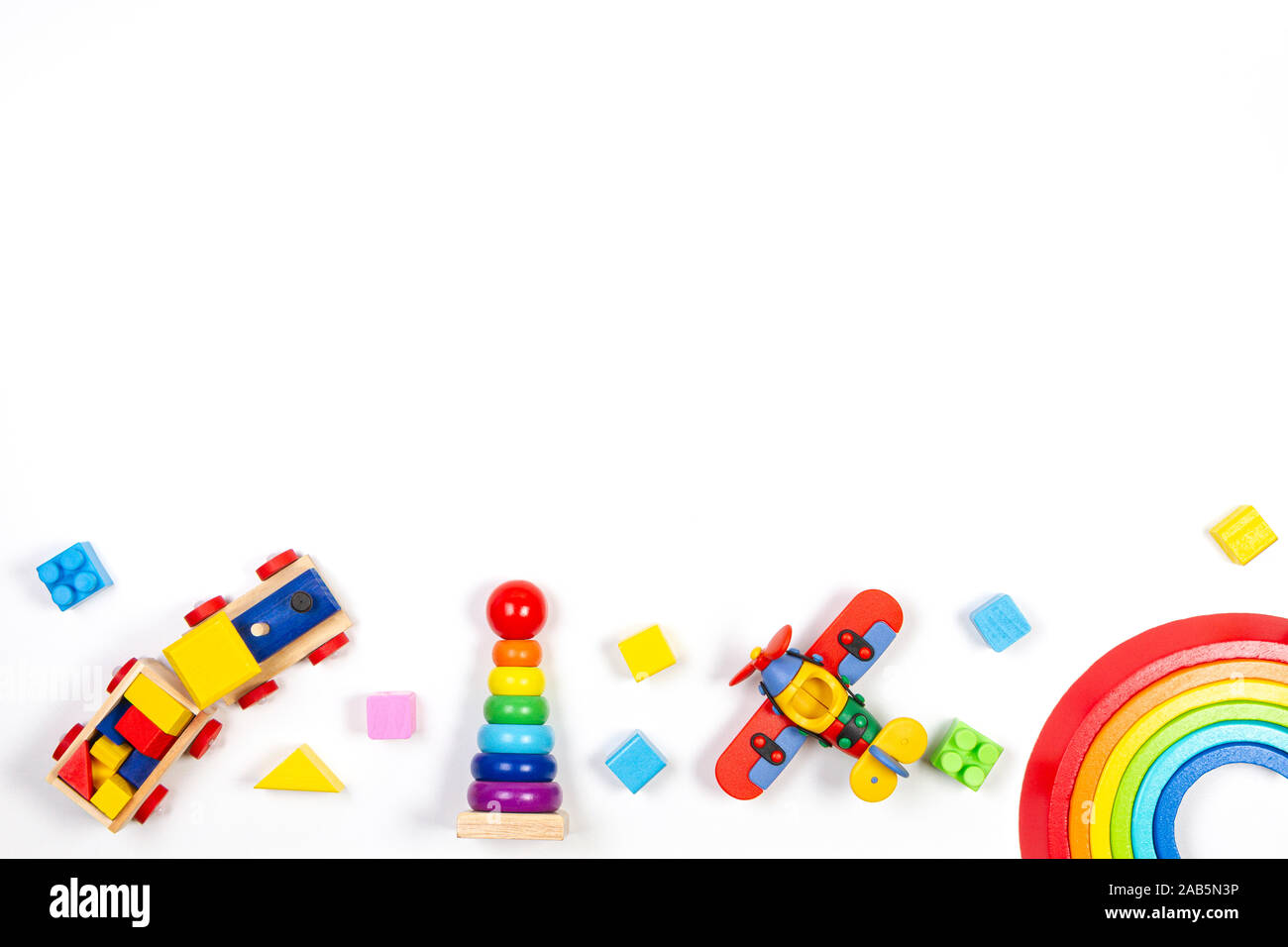 Baby kids toys background. Wooden train, rainbow stacker, red plane ...