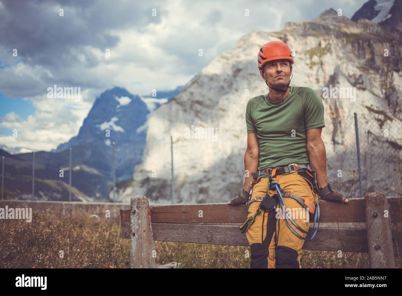Young man climbing on a rock in Swiss Alps - via ferrata/klettersteig ...