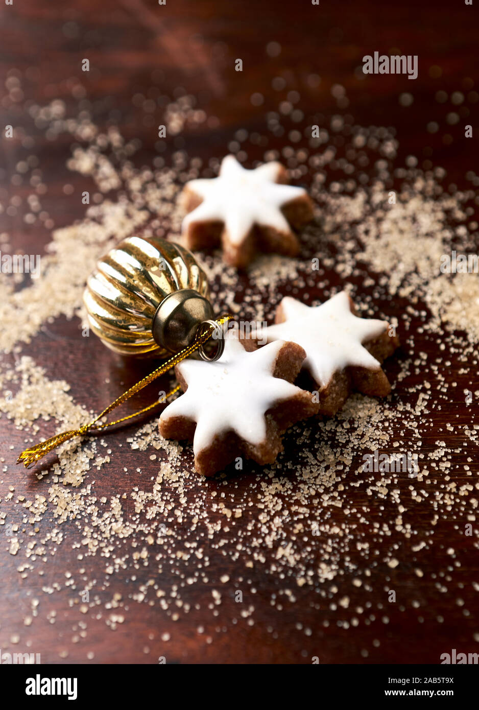 Christmas golden bauble, Christmas cookies (cinnamon stars) and brown ...