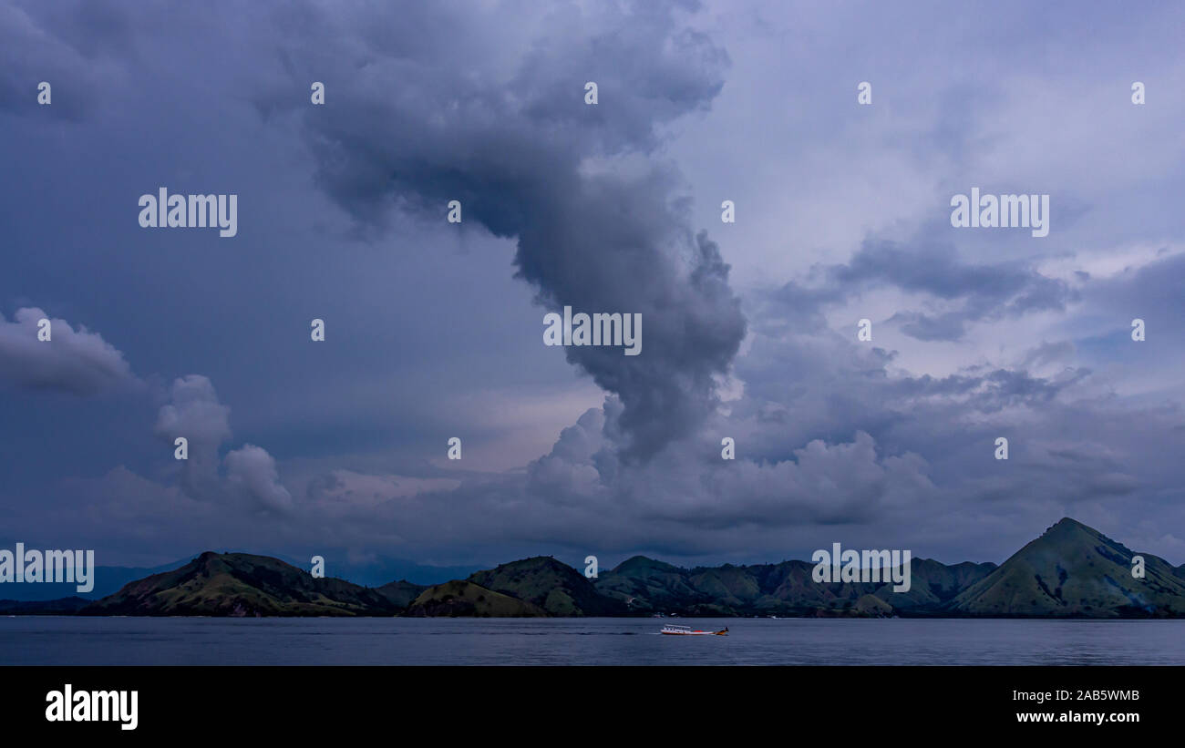 Before the rain, dramatic clouds over island in Komodo National Park ...