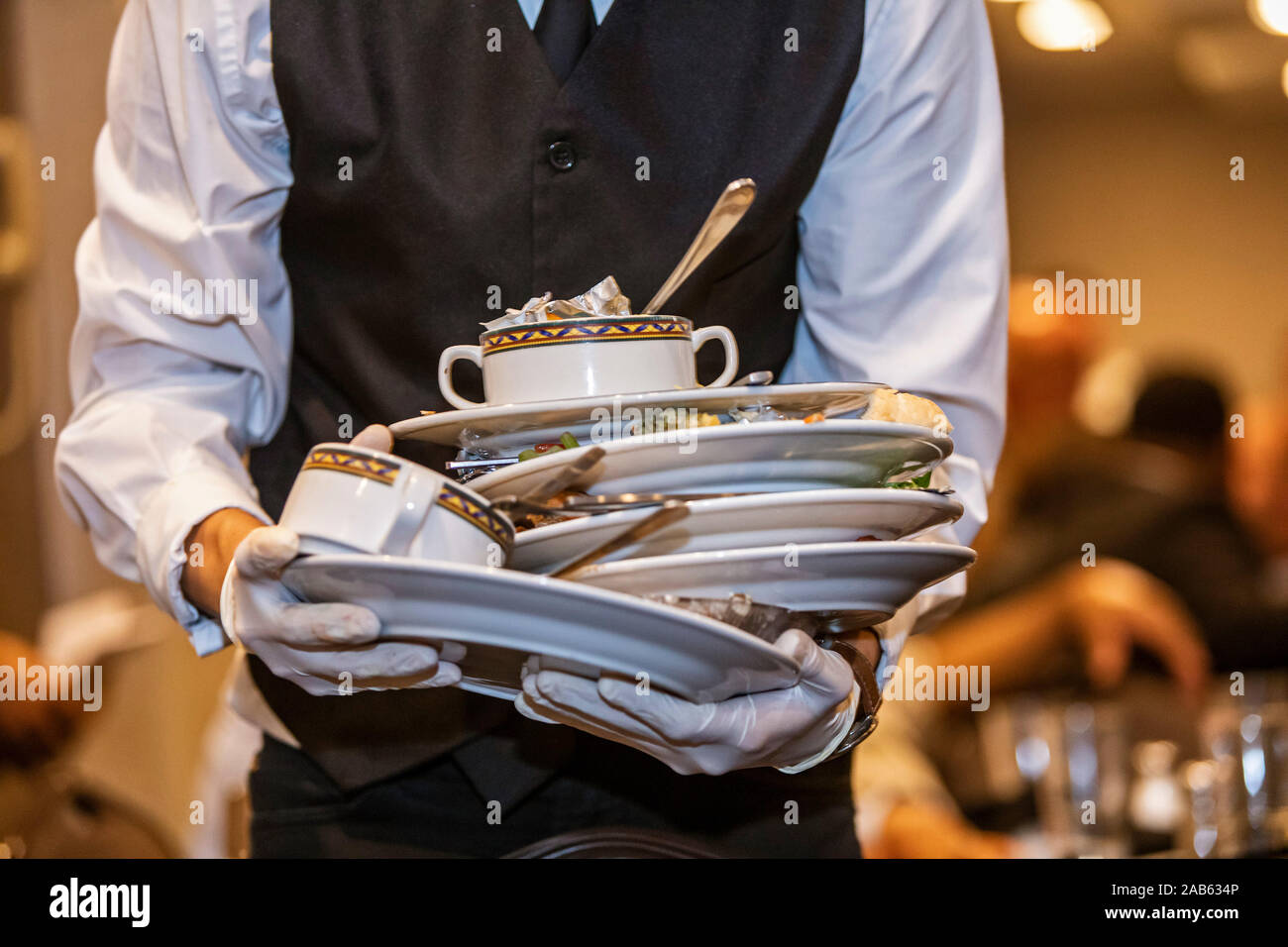Chicago, Illinois - A waiter clears dishes away after a banquet at the ...