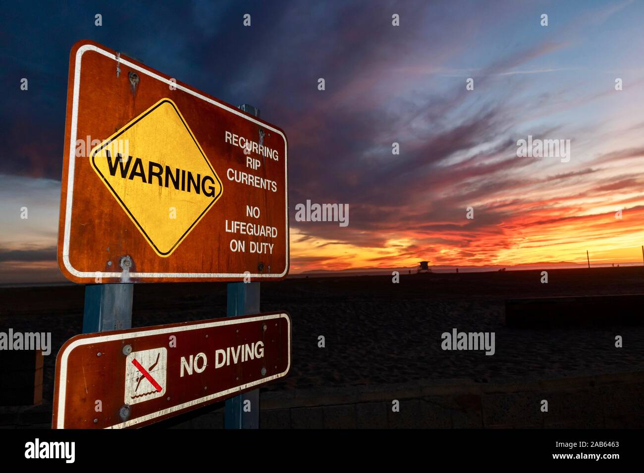 warning sign rip currents at the beach with dramatic sunset Stock Photo ...