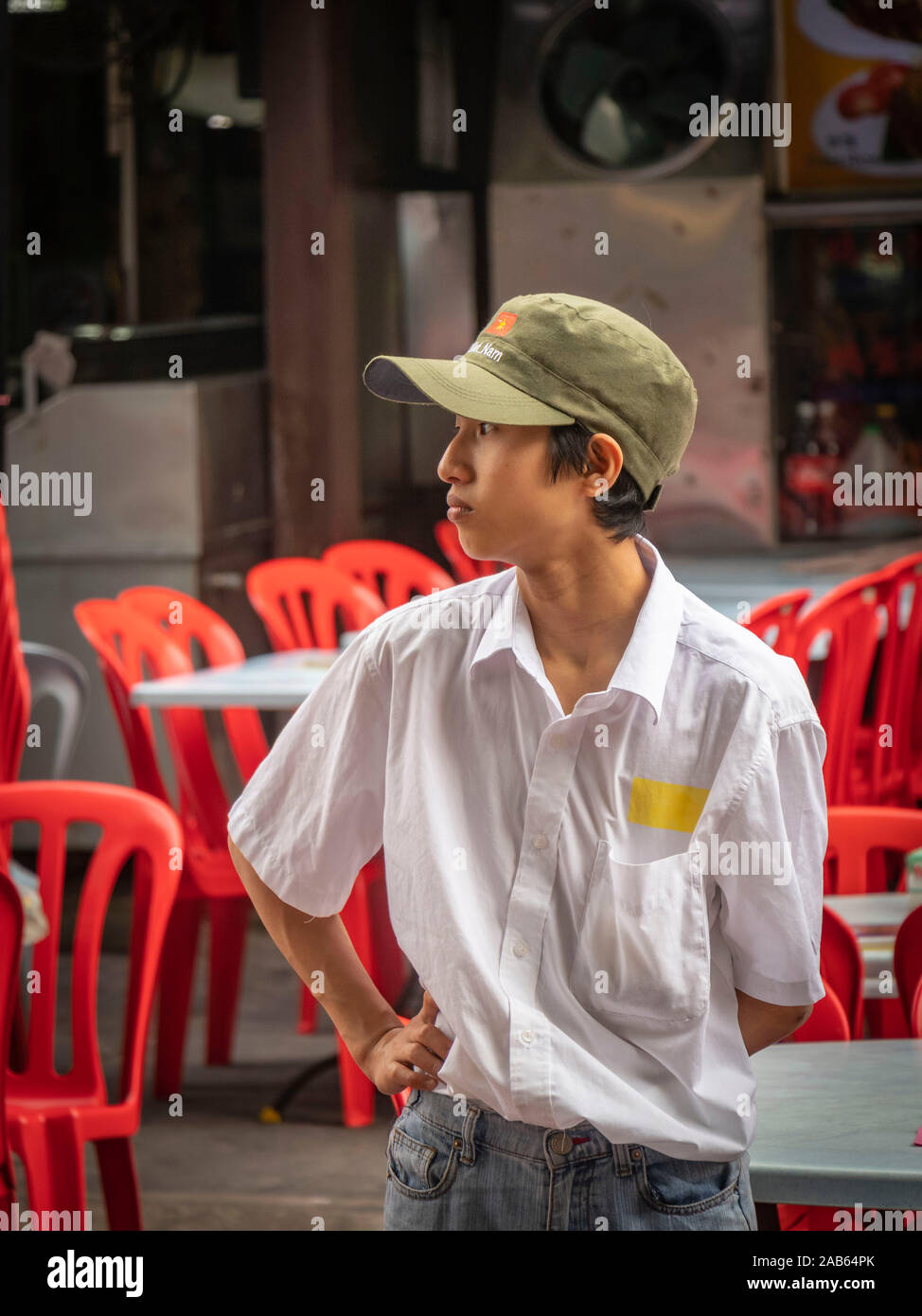 Malaysian youth wearing cap with china star in Jalan Alor food street ...