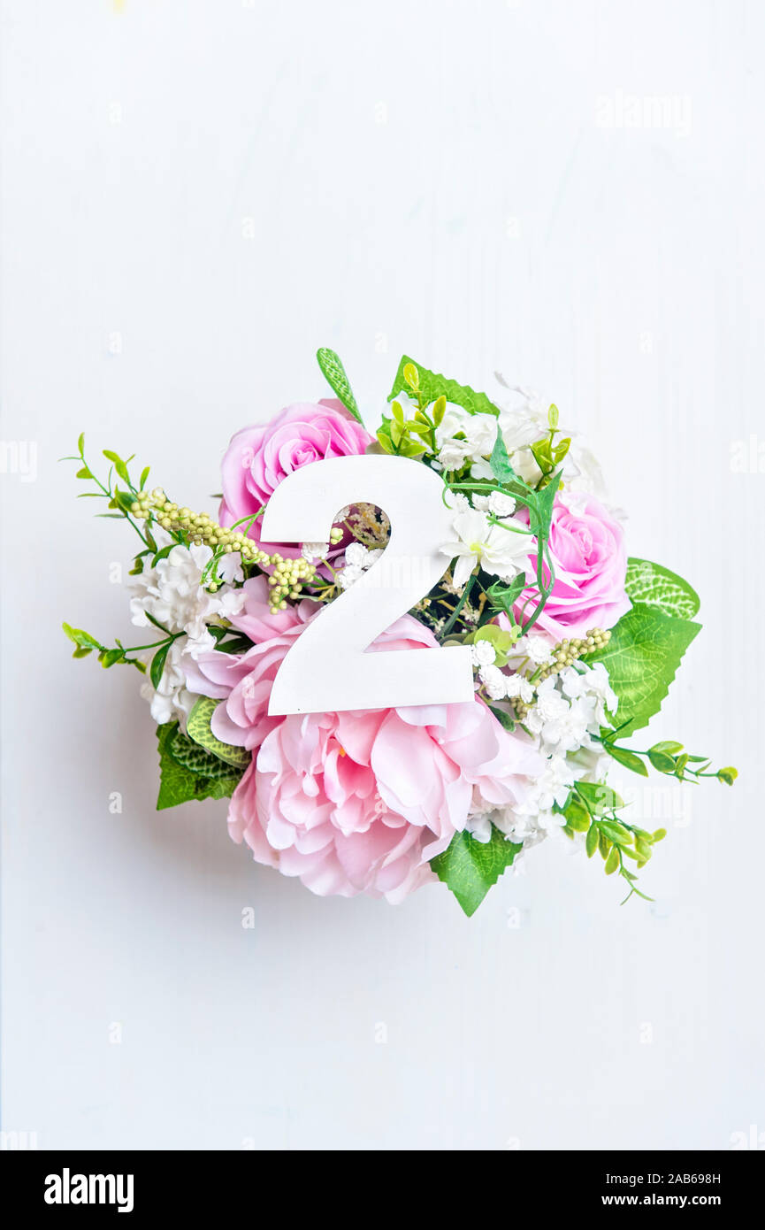 Layout with colorful flowers, leaves and number two. Flat lay. Top view ...