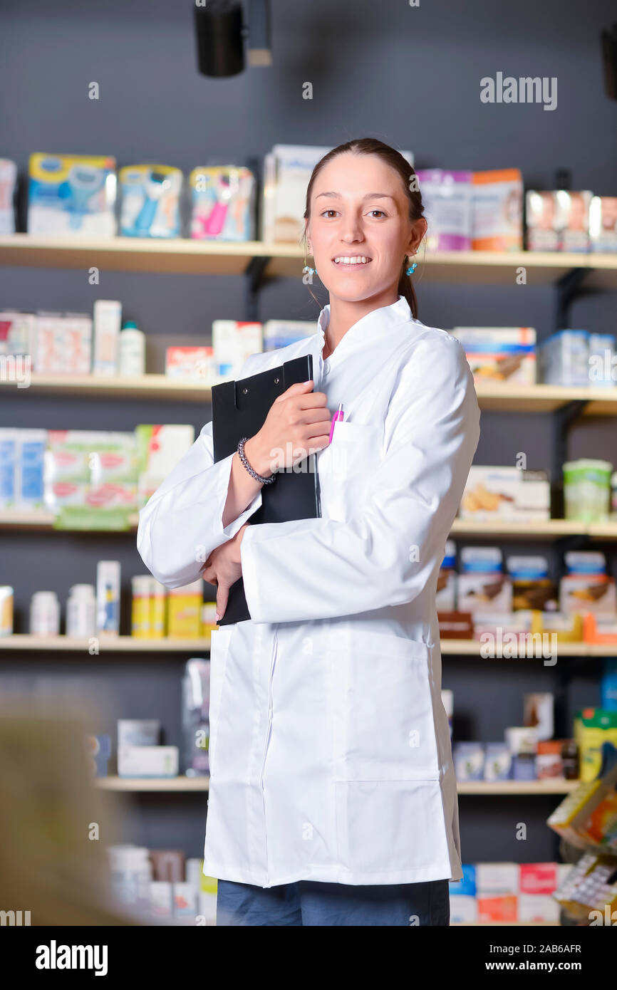 View of an Attractive pharmacist taking notes at work Stock Photo - Alamy