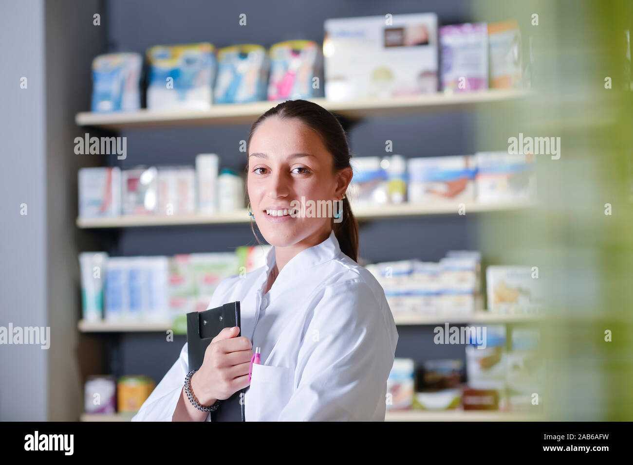 View of an Attractive pharmacist taking notes at work Stock Photo - Alamy