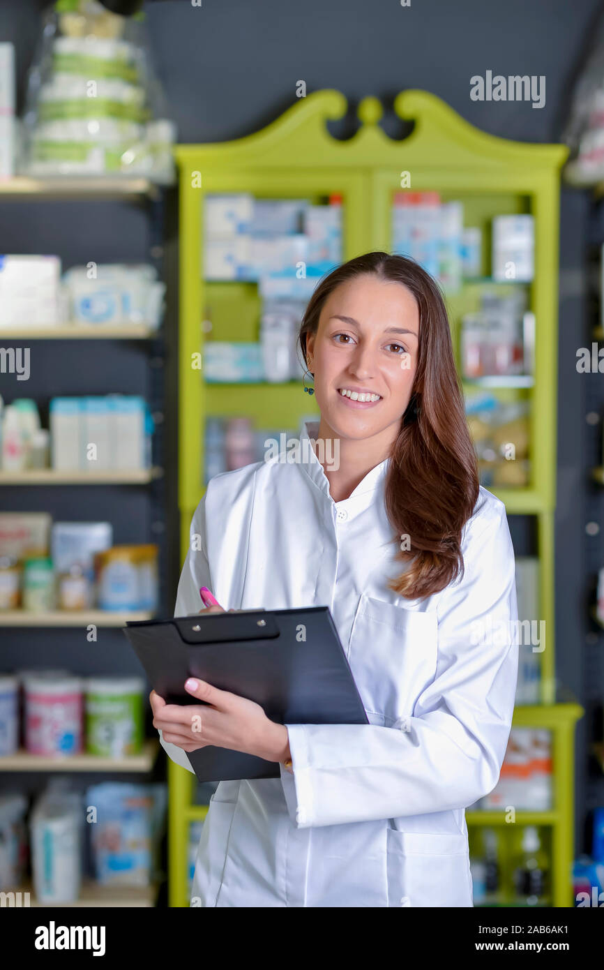 View of an Attractive pharmacist taking notes at work Stock Photo - Alamy
