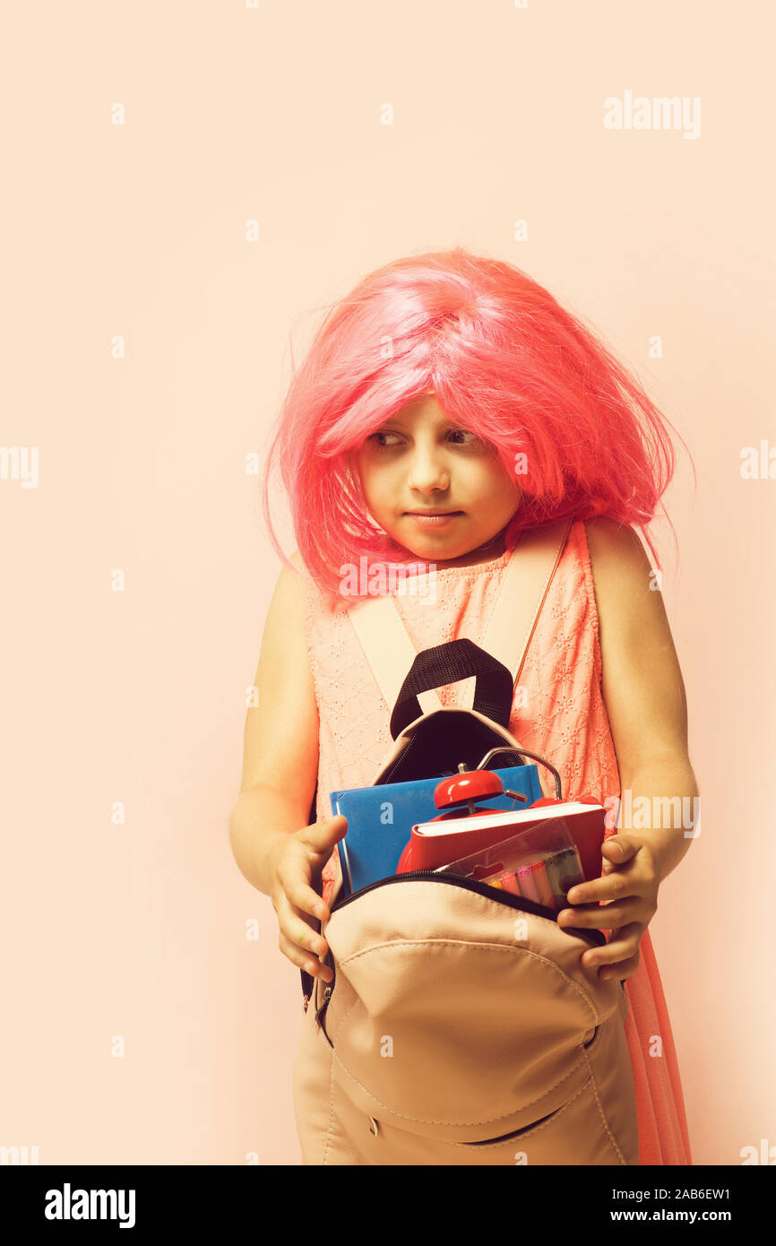 Pupil with scared face expression, isolated on light pink background ...