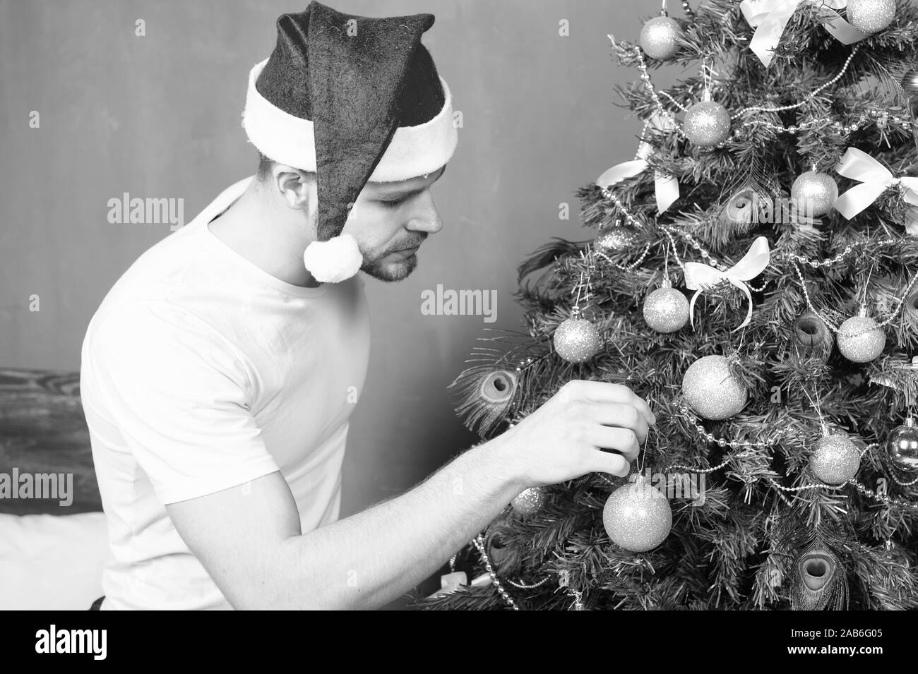 Santa man decorate Christmas tree with golden bauble. Festive ...