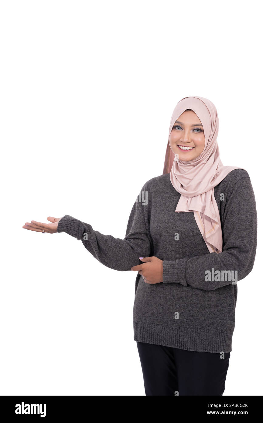 Veiled student stands with a hand gesture holding something looking the ...