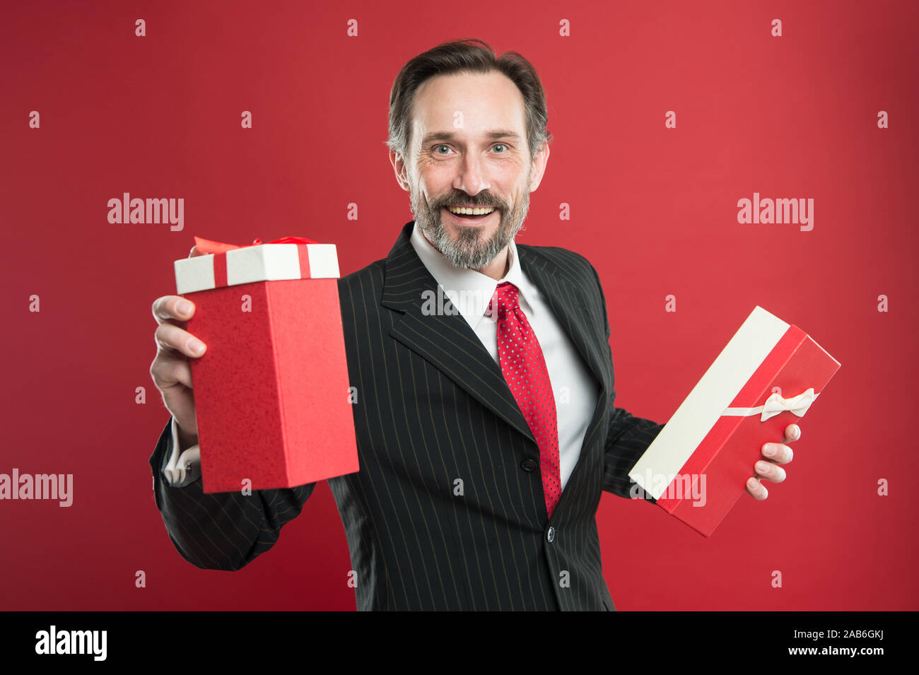 For you. Happy businessman give presents red background. Mature man ...