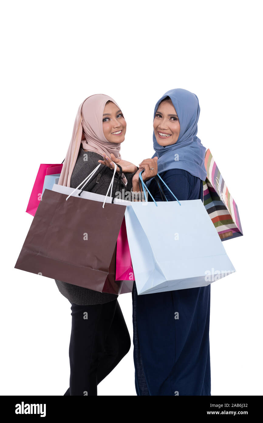 Two veiled women carrying shopping bag Stock Photo - Alamy
