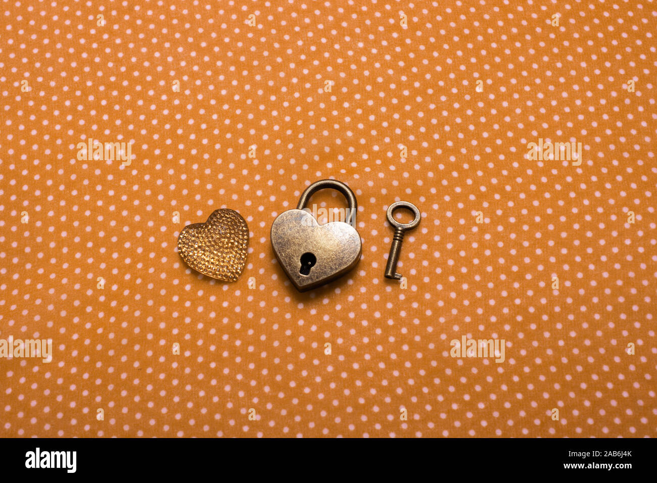 Heart shaped lock and key on a red background Stock Photo - Alamy