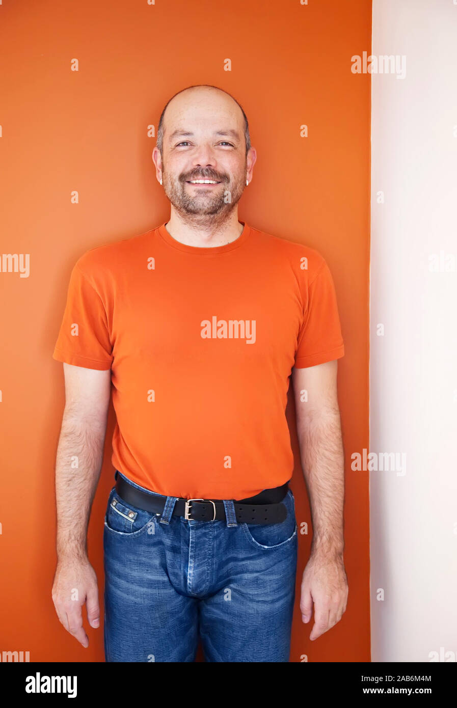 A photography of a man in front of a orange background Stock Photo - Alamy