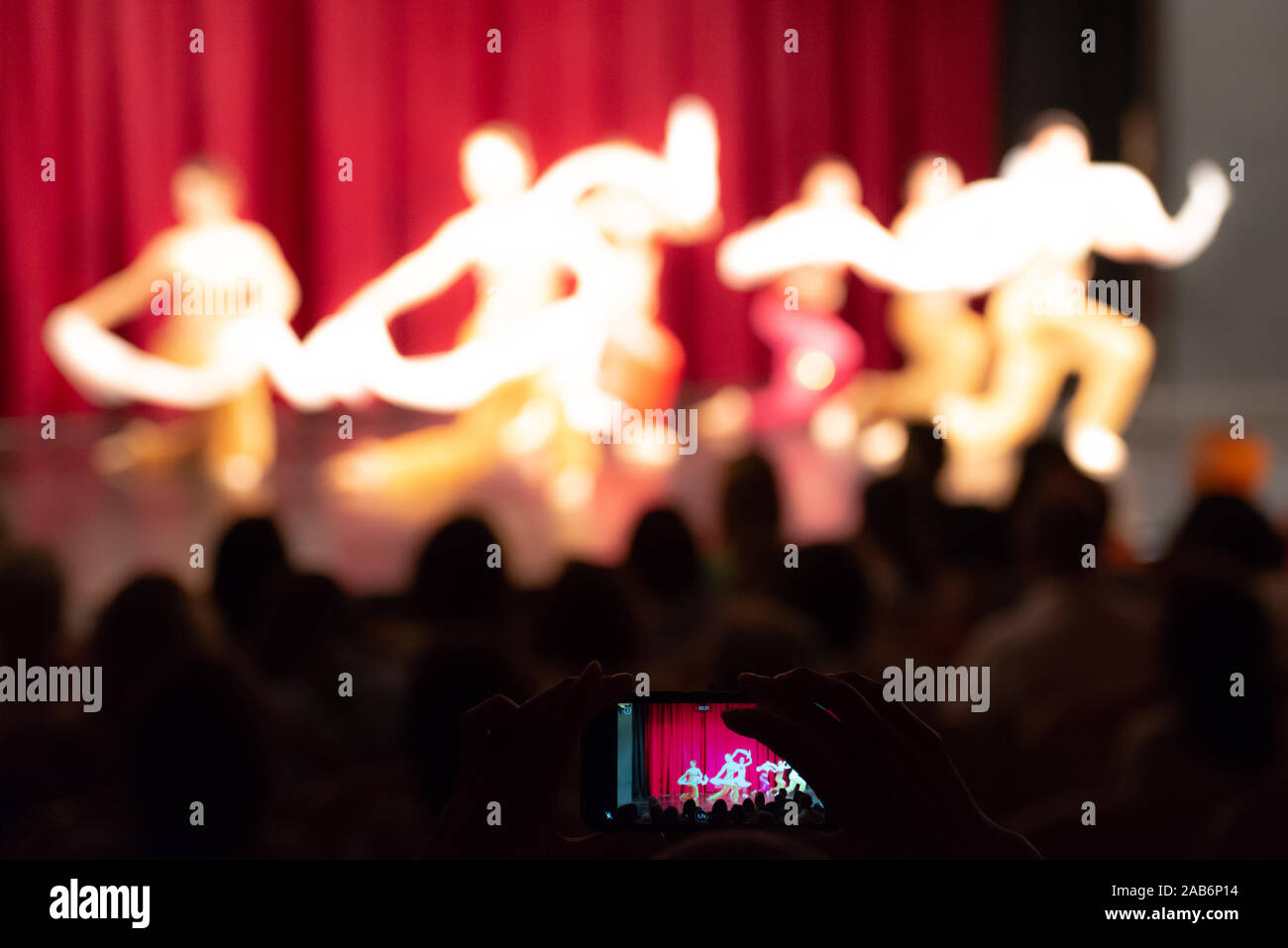 Concert dance group. Blurred figures on the stage, clear on the phone ...