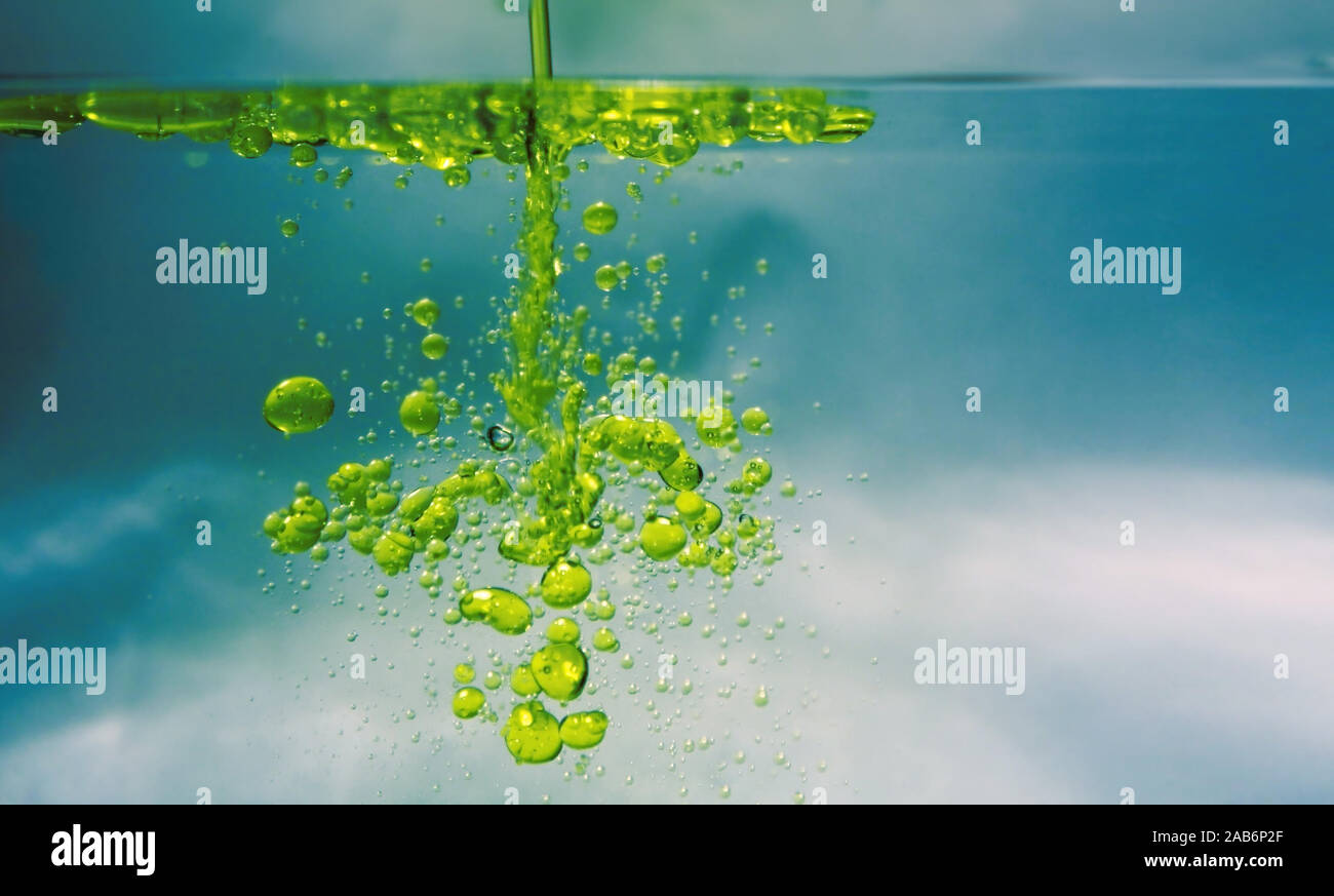 A photography of oil entering a water basin Stock Photo - Alamy
