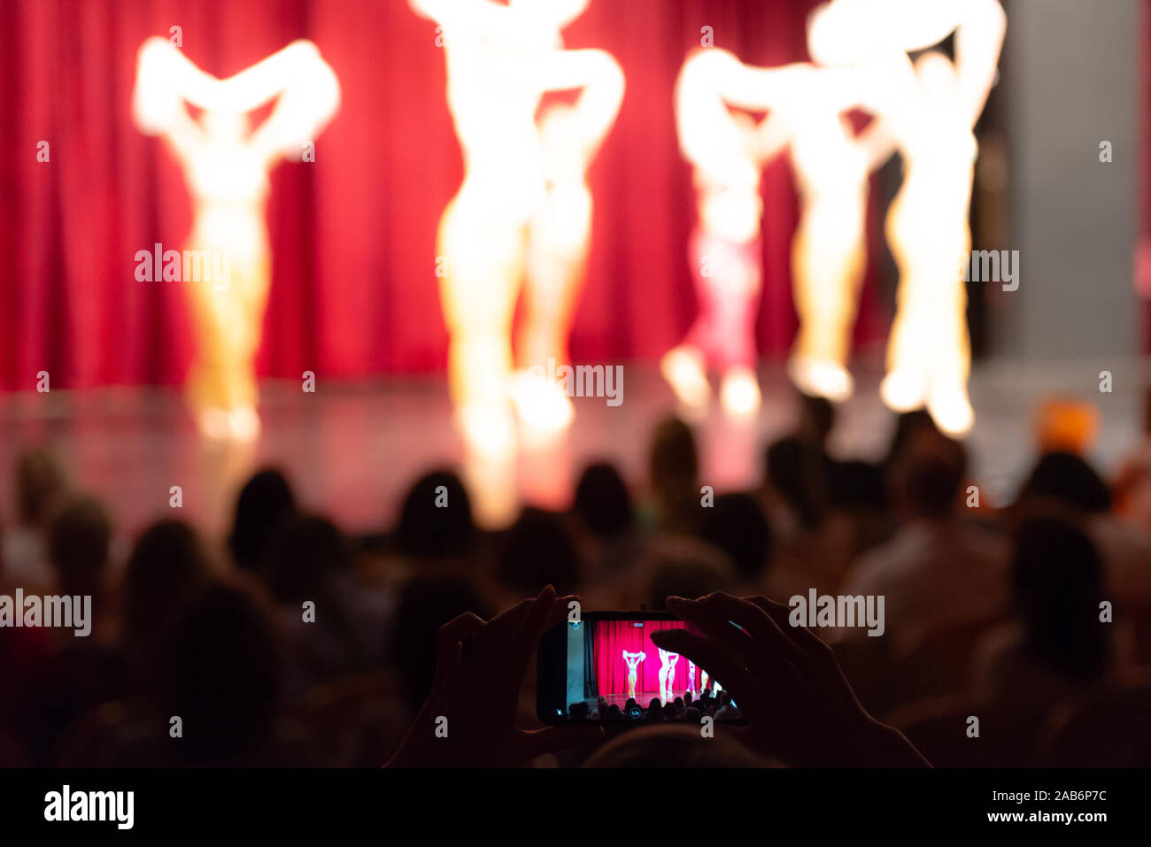 Concert dance group. Blurred figures on the stage, clear on the phone ...