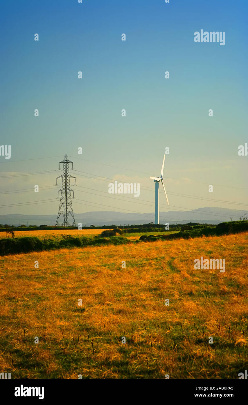 A photography of a power pole and wind mill Stock Photo - Alamy