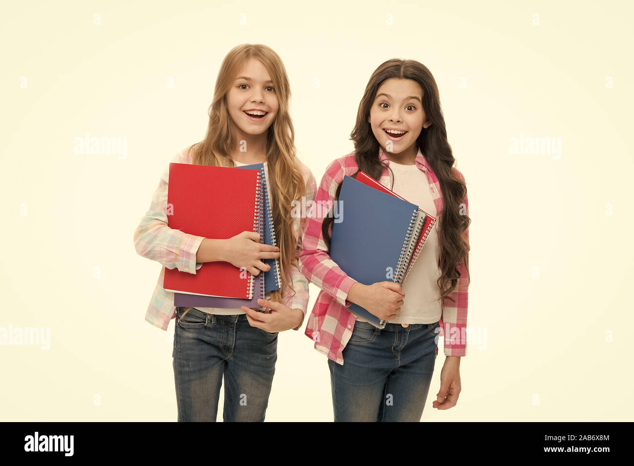 Pads perfect for the academic use. Cute small school children holding ...