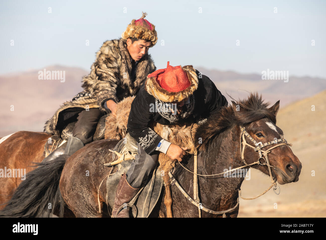 Kazakh eagle hunters partaking in a traditional wrestling match. Two ...