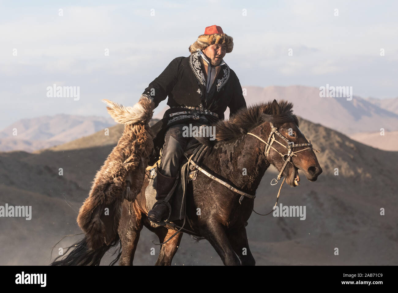 Kazakh eagle hunters partaking in a traditional wrestling match. Two ...