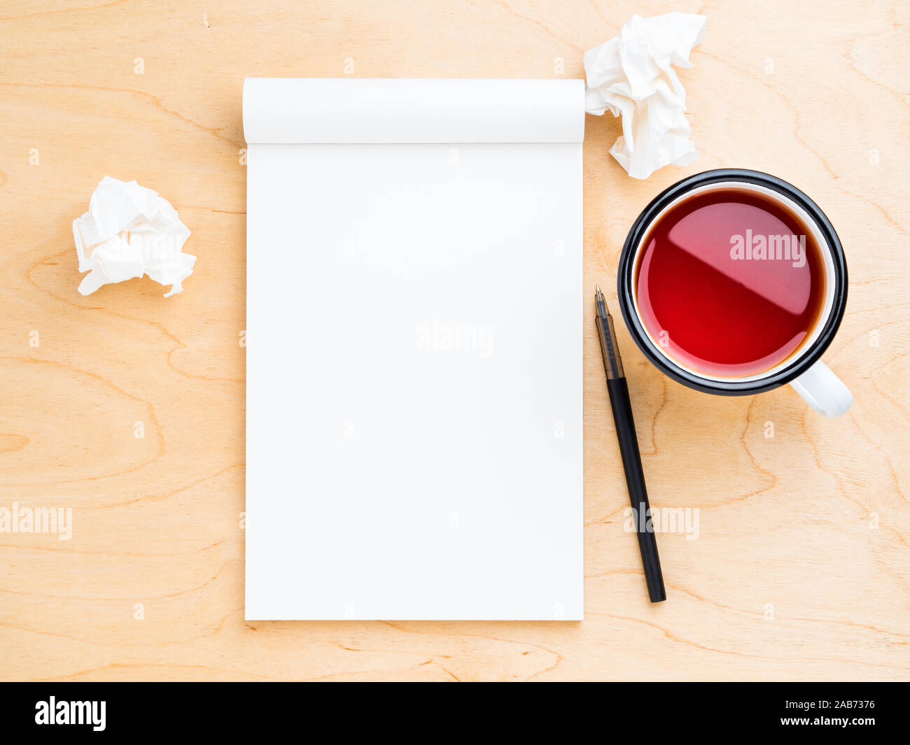 Open notebook with a white clean sheet for notes and drawing, wrinkled ...